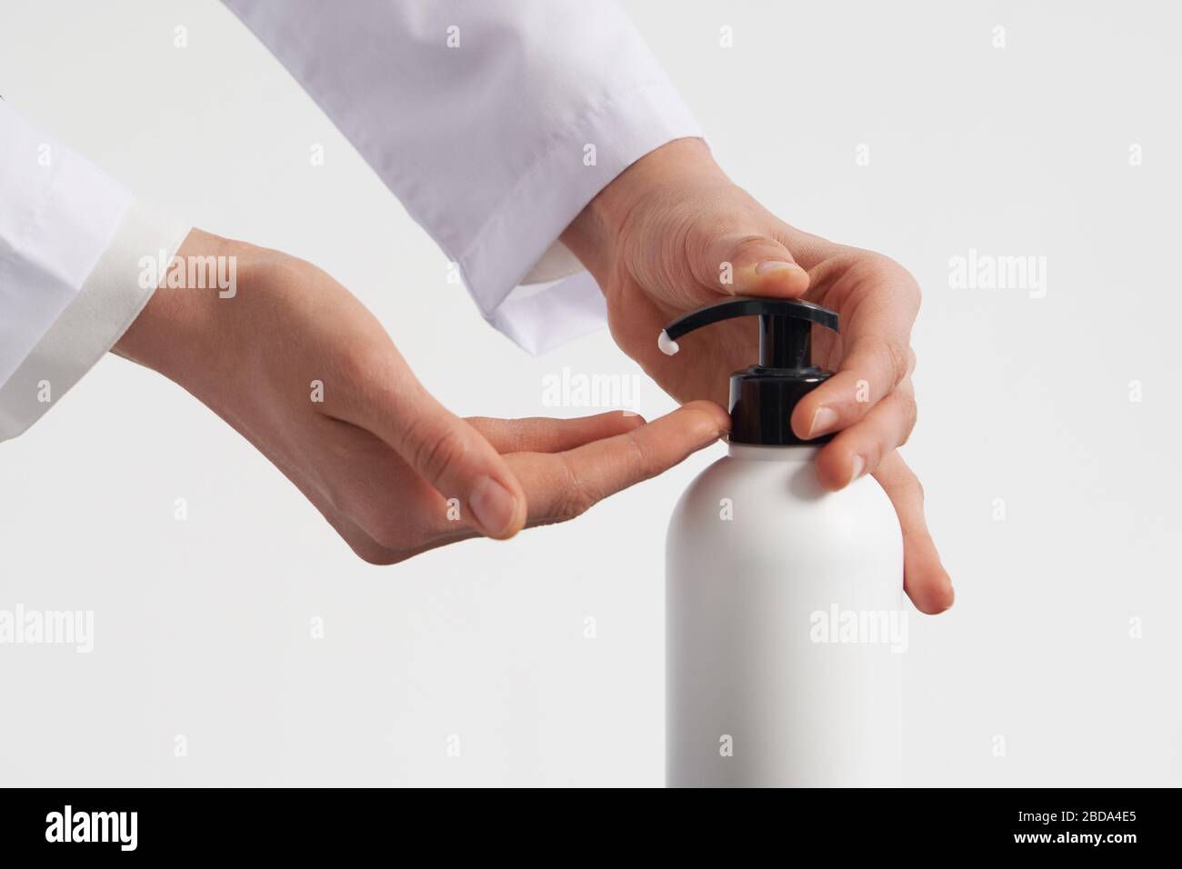 Woman hands pushing pump plastic soap bottle with copy space, using ...