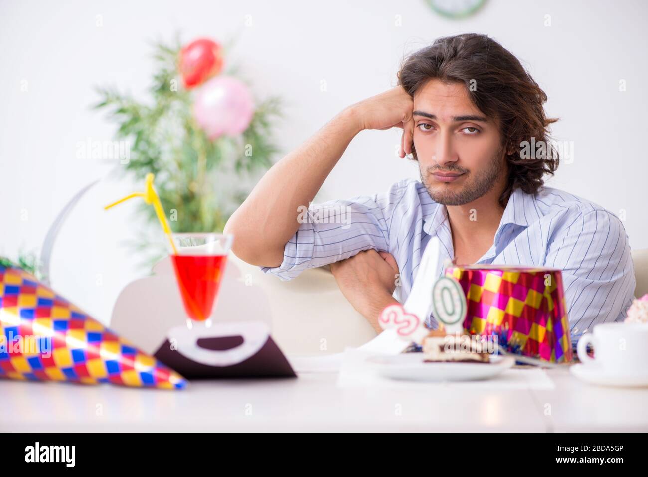 The young man celebrating his birthday at home Stock Photo - Alamy