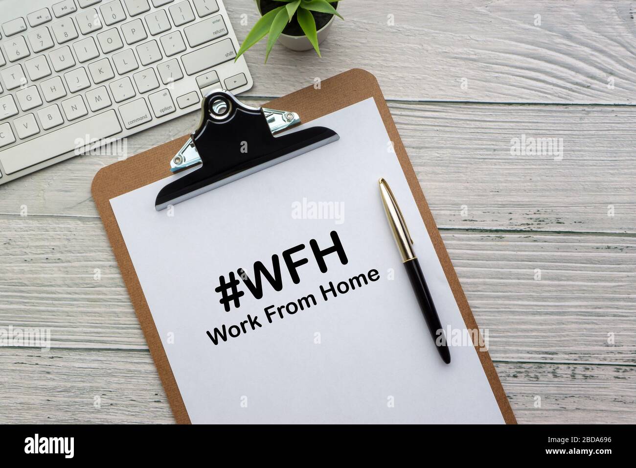 WORK FROM HOME #WFH text with notepad, keyboard, decorative vase and ...