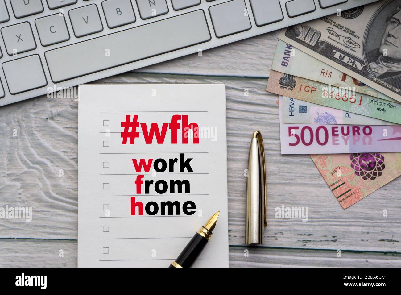 WORK FROM HOME #WFH text with notepad, keyboard, fountain pen and ...