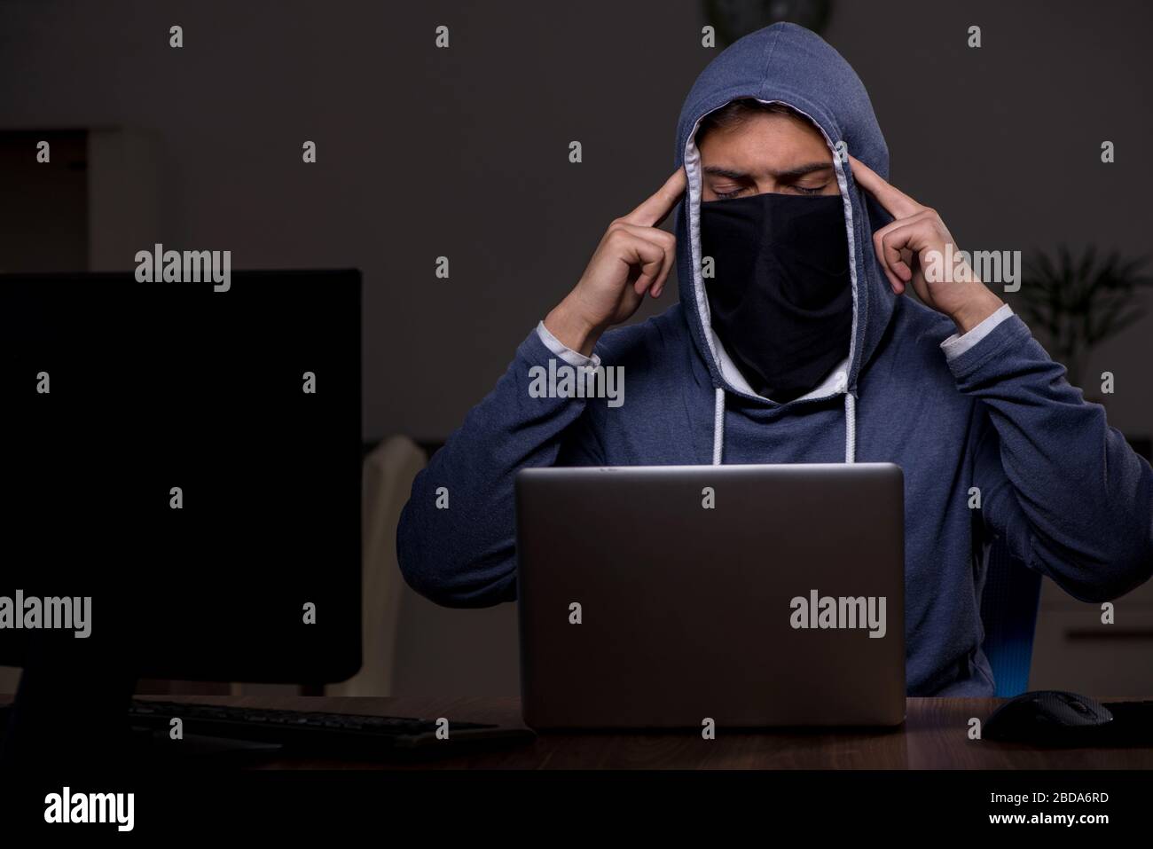 Male hacker hacking security firewall late in the office Stock Photo ...