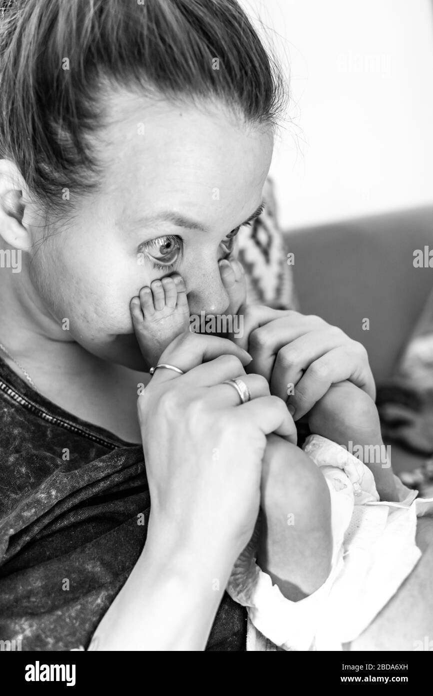Portrait of a mother very tired from her baby, with a sad look full of ...