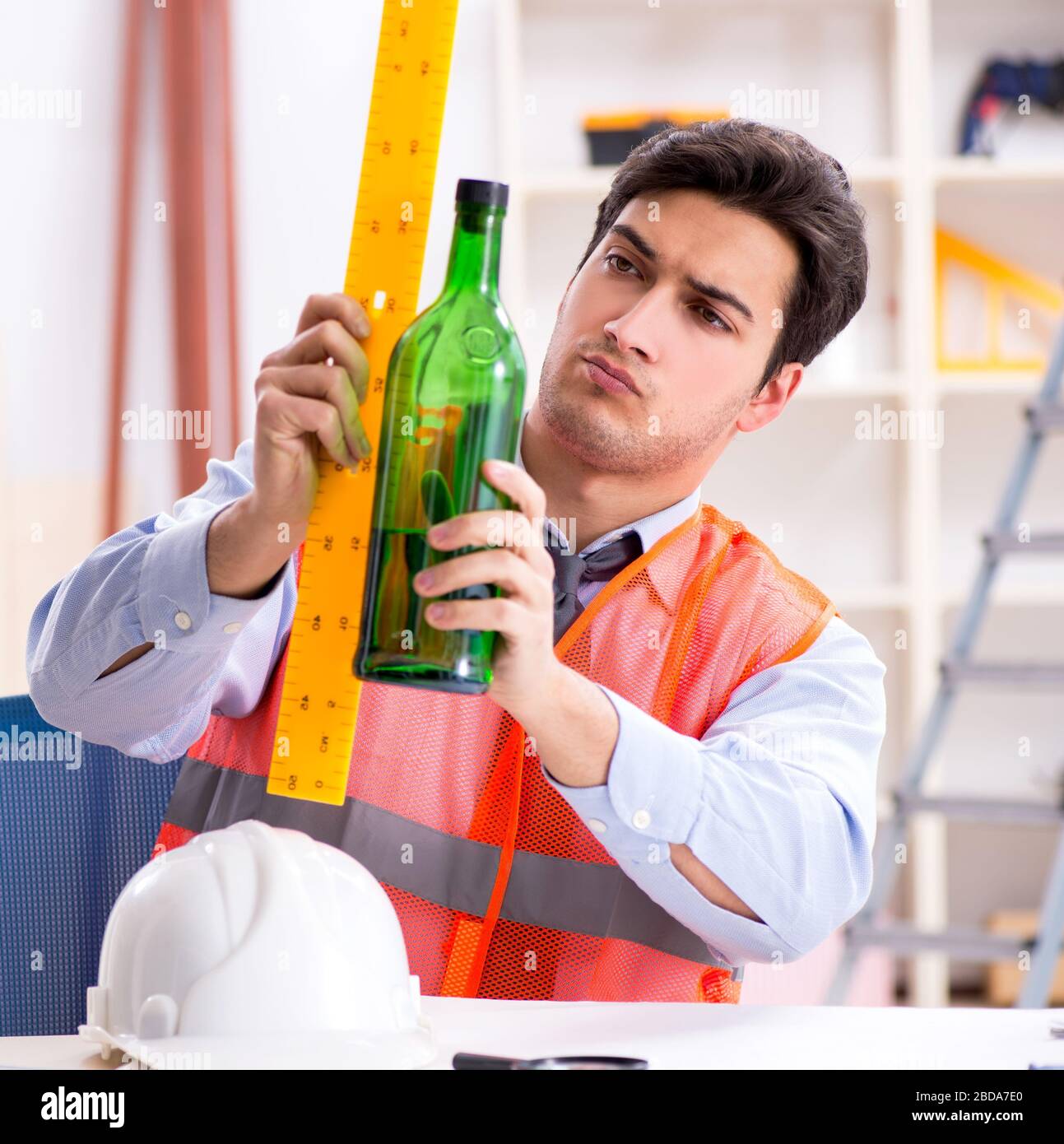 The drunk engineer working in the workshop Stock Photo - Alamy