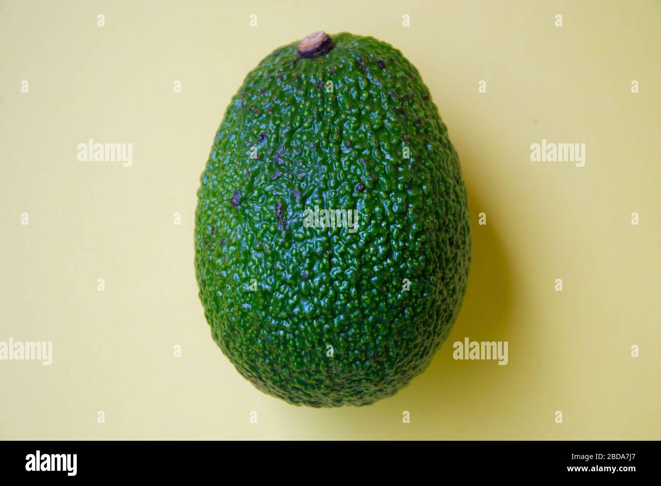 Whole green ripe avocado, close-up fruit, healthy eating concept ...