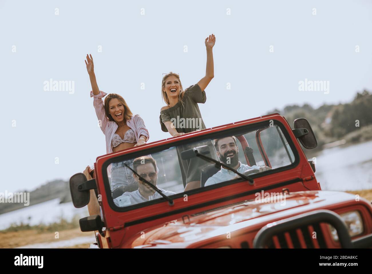 Group of happy young people enjoying road trip Stock Photo - Alamy