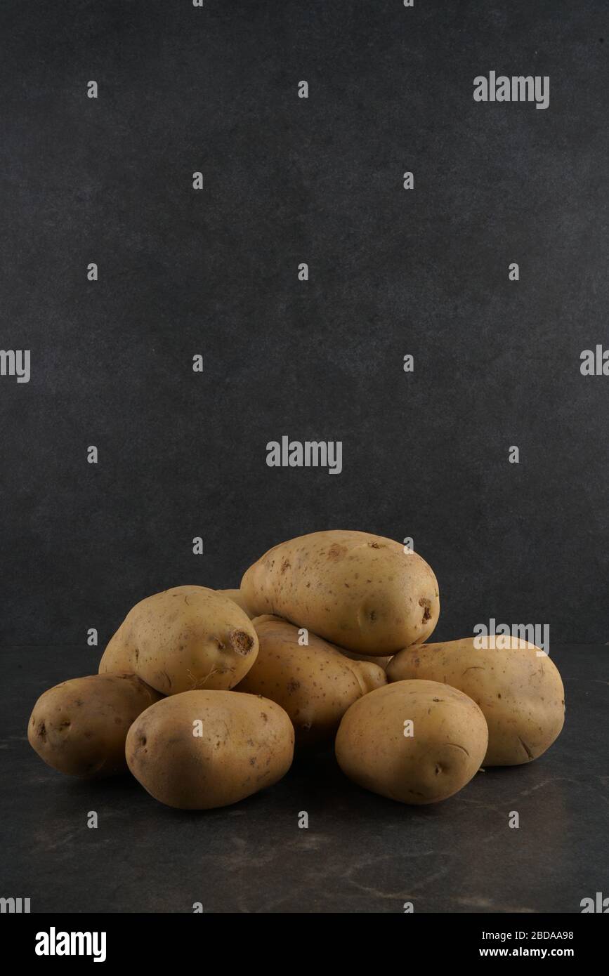 Fresh Patato on dark background Stock Photo - Alamy