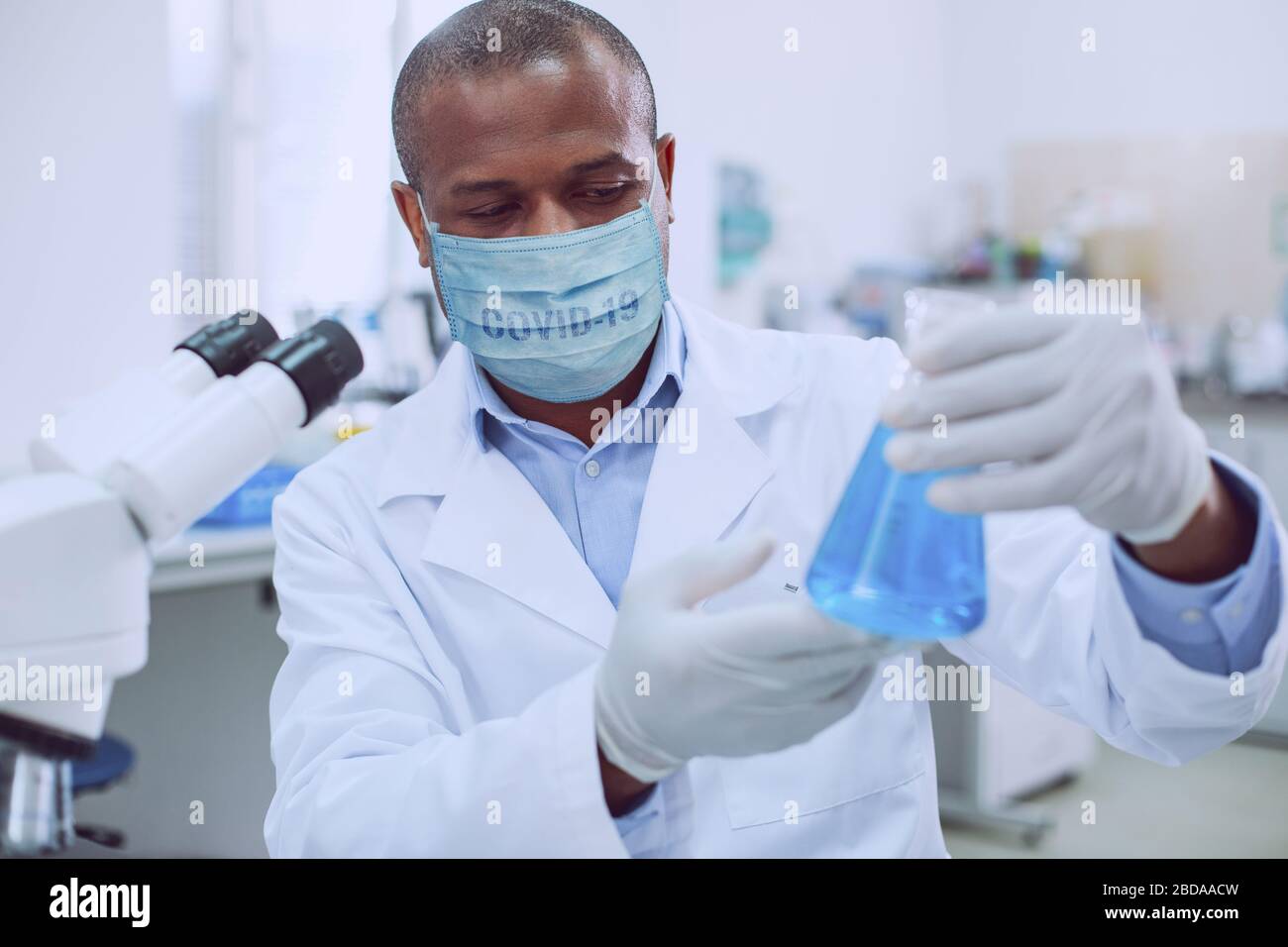Professional lab worker wearing a medical mask Stock Photo - Alamy