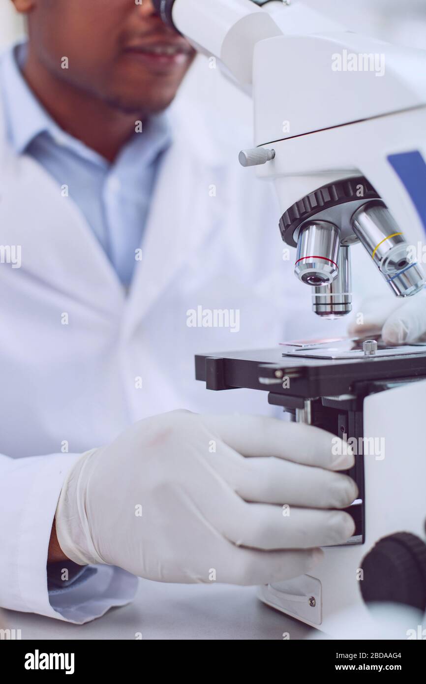 Smart biologist working on a cutting-edge microscope Stock Photo - Alamy