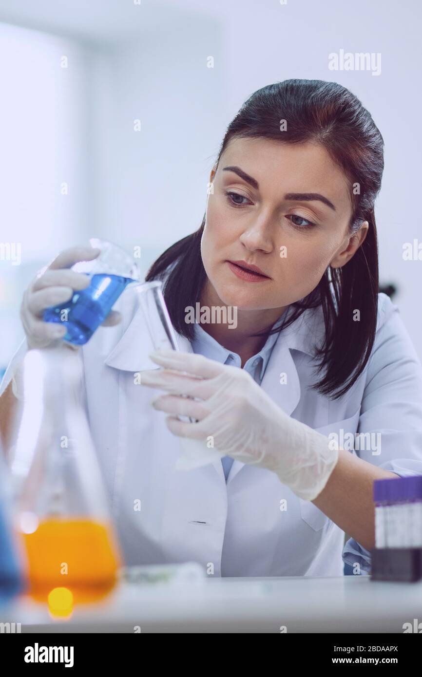 Inspired female scientist doing a new test Stock Photo - Alamy