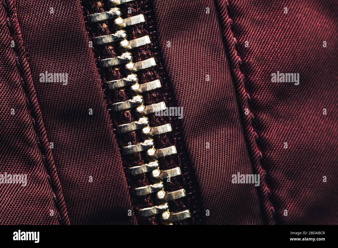 Close up beautiful zipper on red textile cloth background with ...
