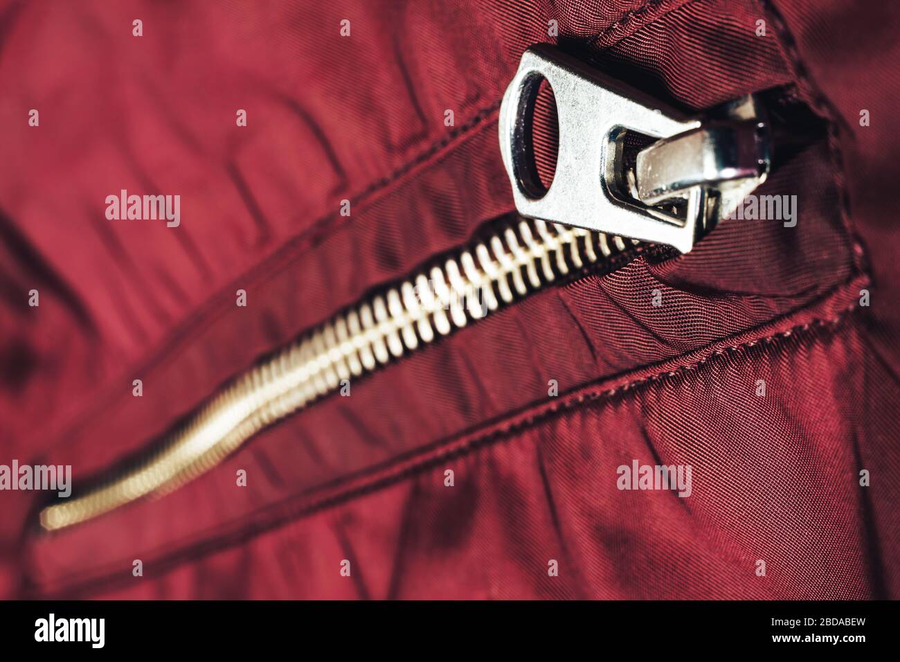 Close up beautiful zipper on red textile cloth background with ...