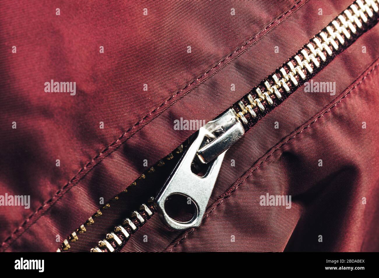 Close up beautiful zipper on red textile cloth background with ...