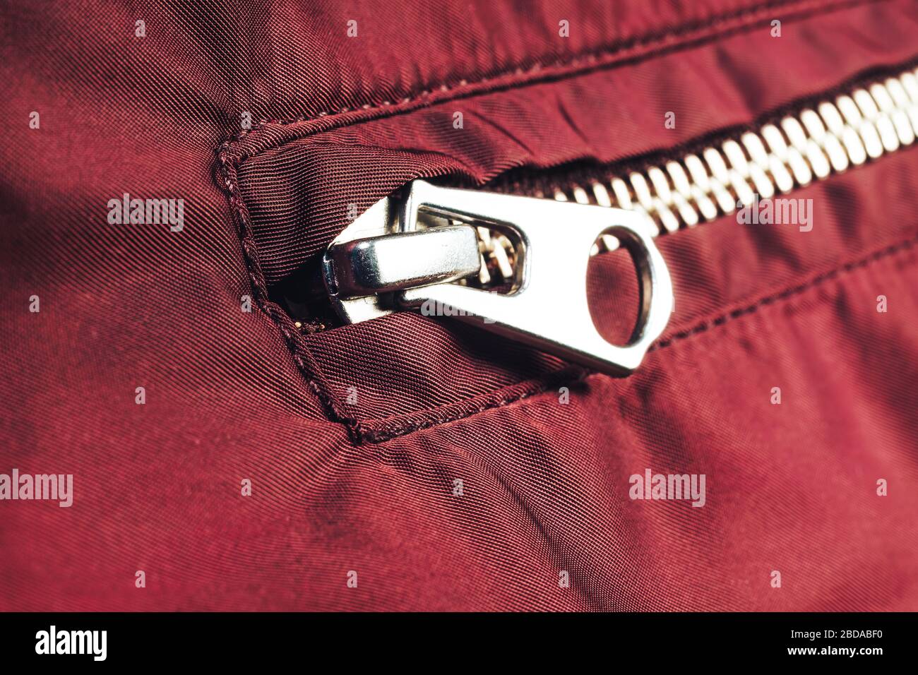 Close up beautiful zipper on red textile cloth background with ...