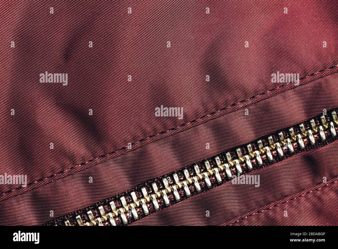 Close up beautiful zipper on red textile cloth background with ...