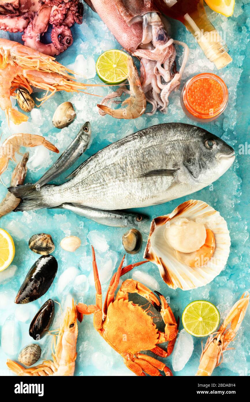 Fish and seafood variety, a flat lay. Sea bream, scallop, shrimps, crab ...