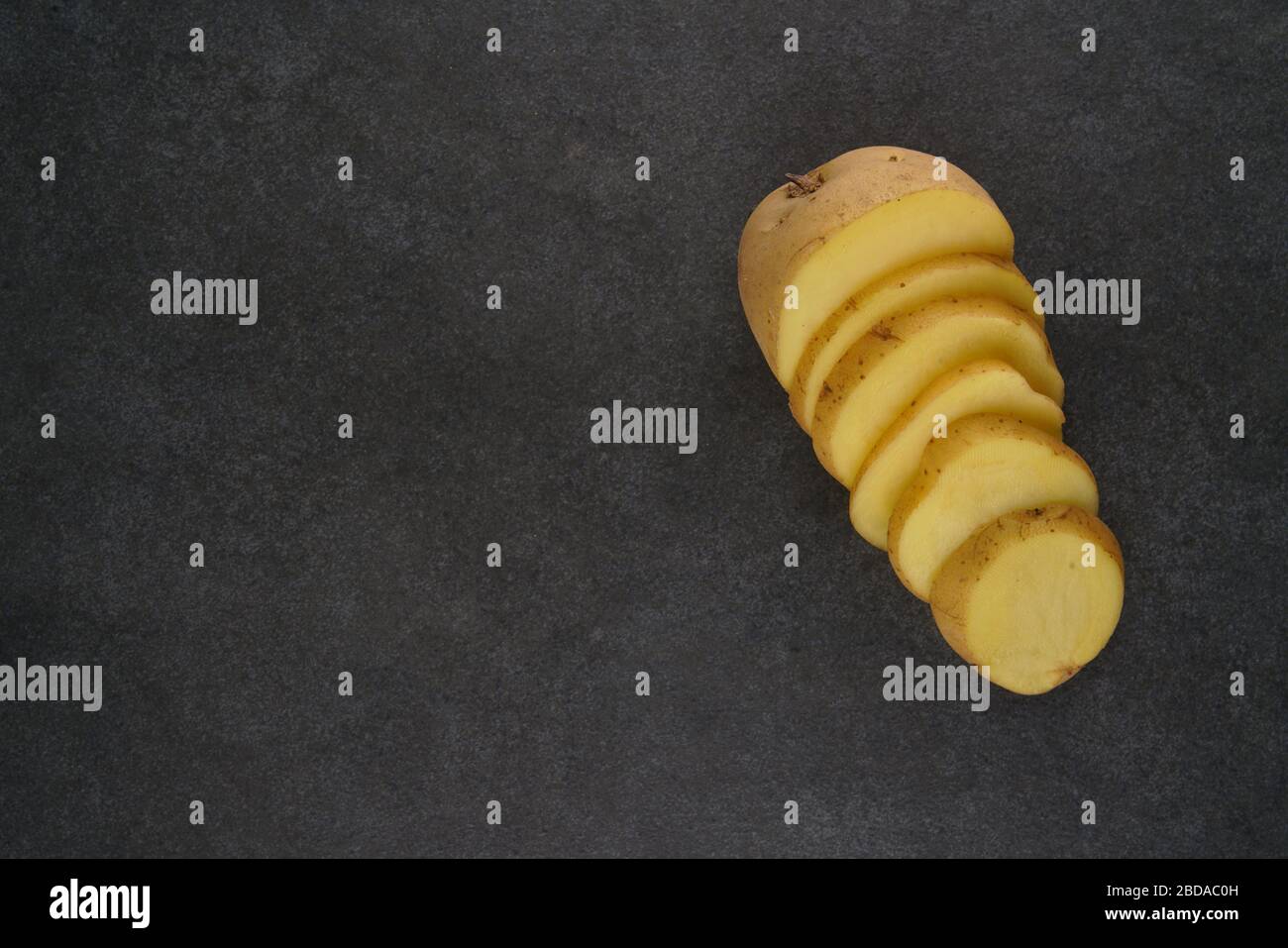 Fresh patato on dark background Stock Photo - Alamy