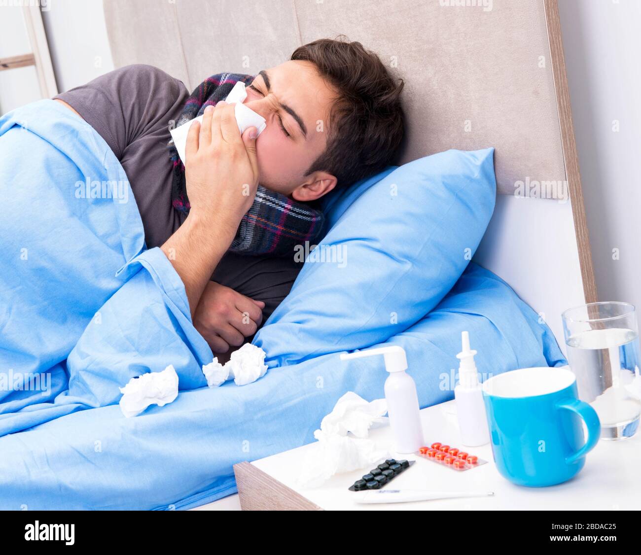 The sick man with flu lying in the bed Stock Photo - Alamy