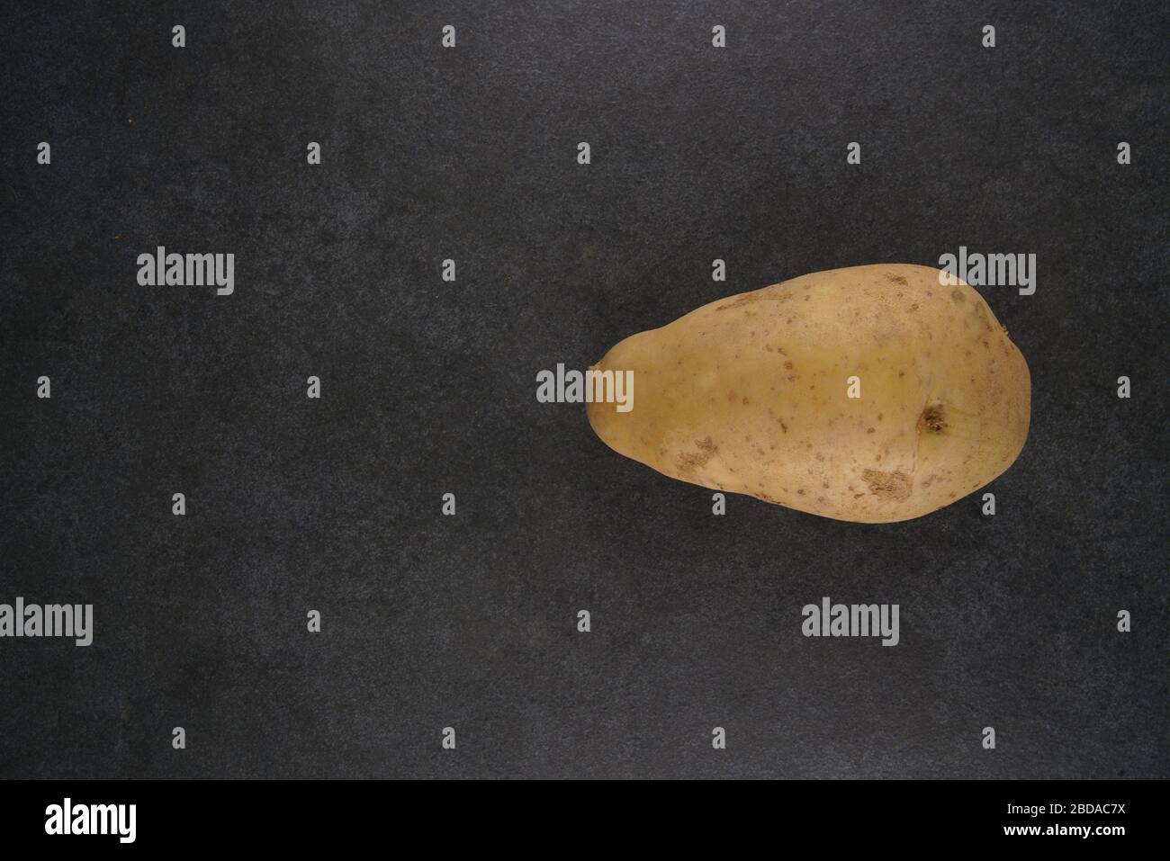 Fresh patato on dark background Stock Photo - Alamy