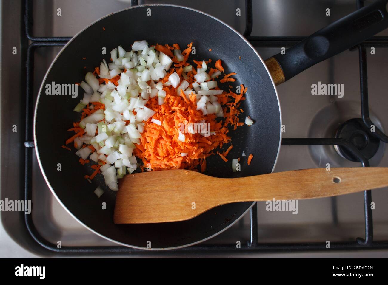 Grated carrot and onion in a frying pan Stock Photo - Alamy