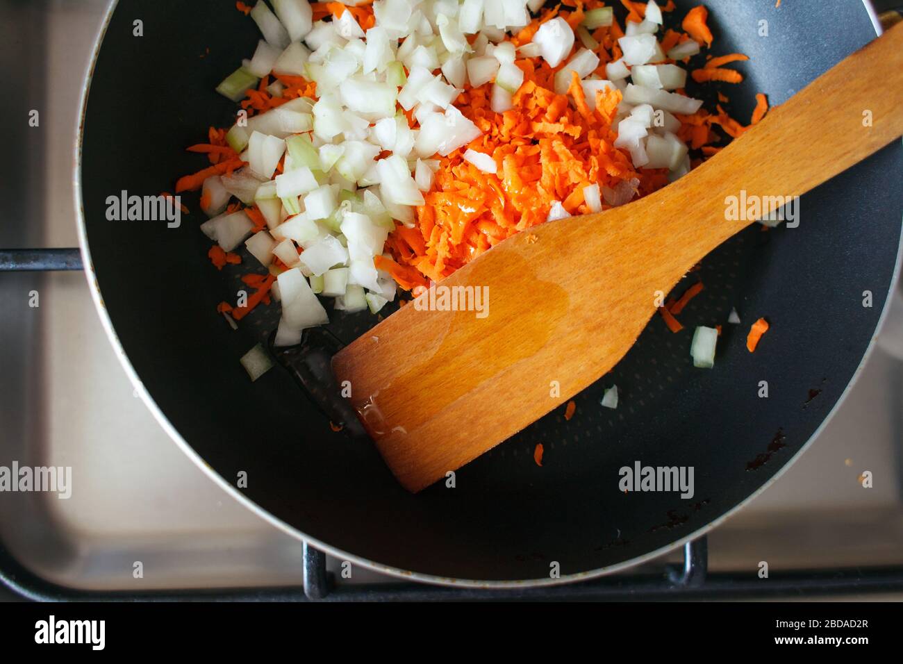 Grated carrot and onion in a frying pan Stock Photo - Alamy