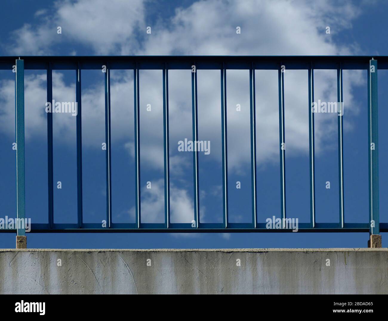 steel guard rail with vertical pickets and posts along highway. blue ...