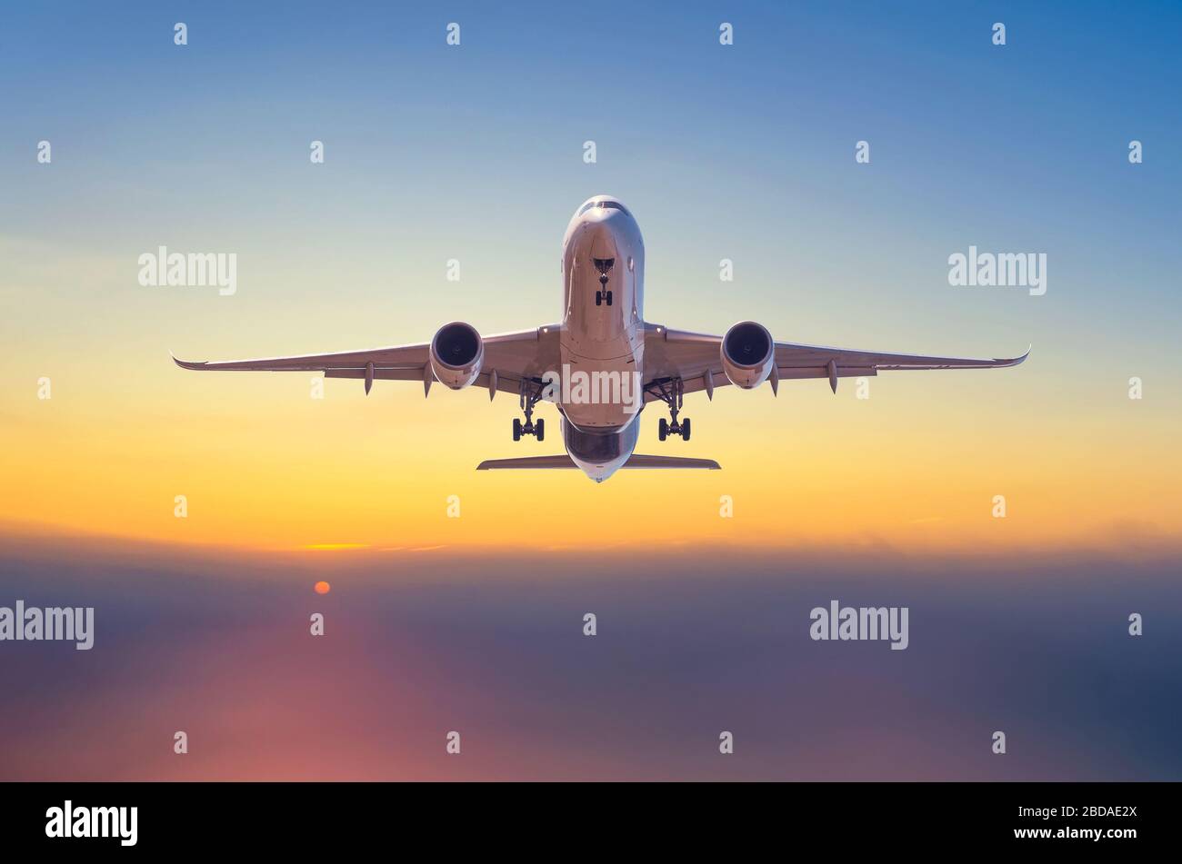 Morning fog with the rising sun and a plane taking off in the sky Stock ...