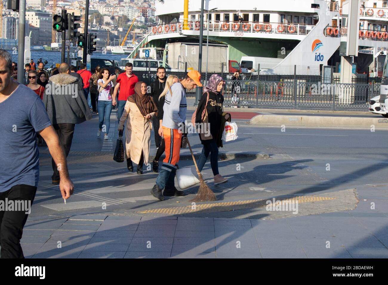 Traffic lights and people crossing the pedestrian path. A municipal ...