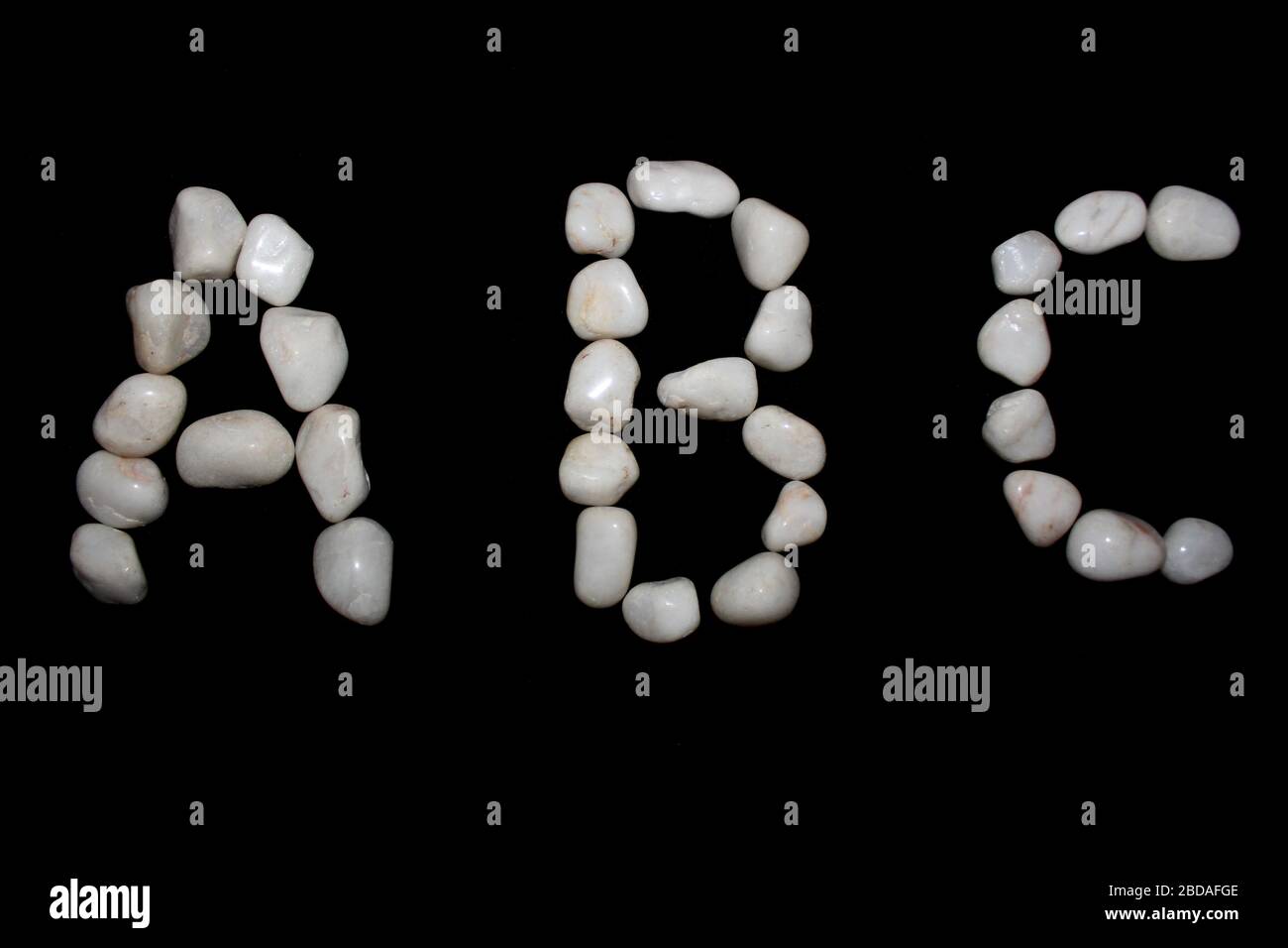 white royal sapphire rock pebbles letter, alphabet photographed against ...