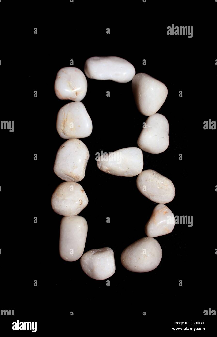 white royal sapphire rock pebbles letter, alphabet photographed against ...