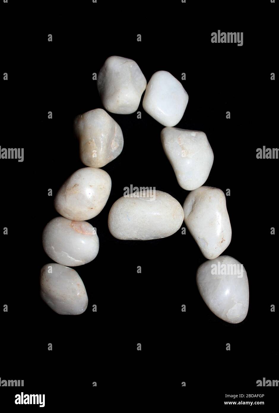 white royal sapphire rock pebbles letter, alphabet photographed against ...