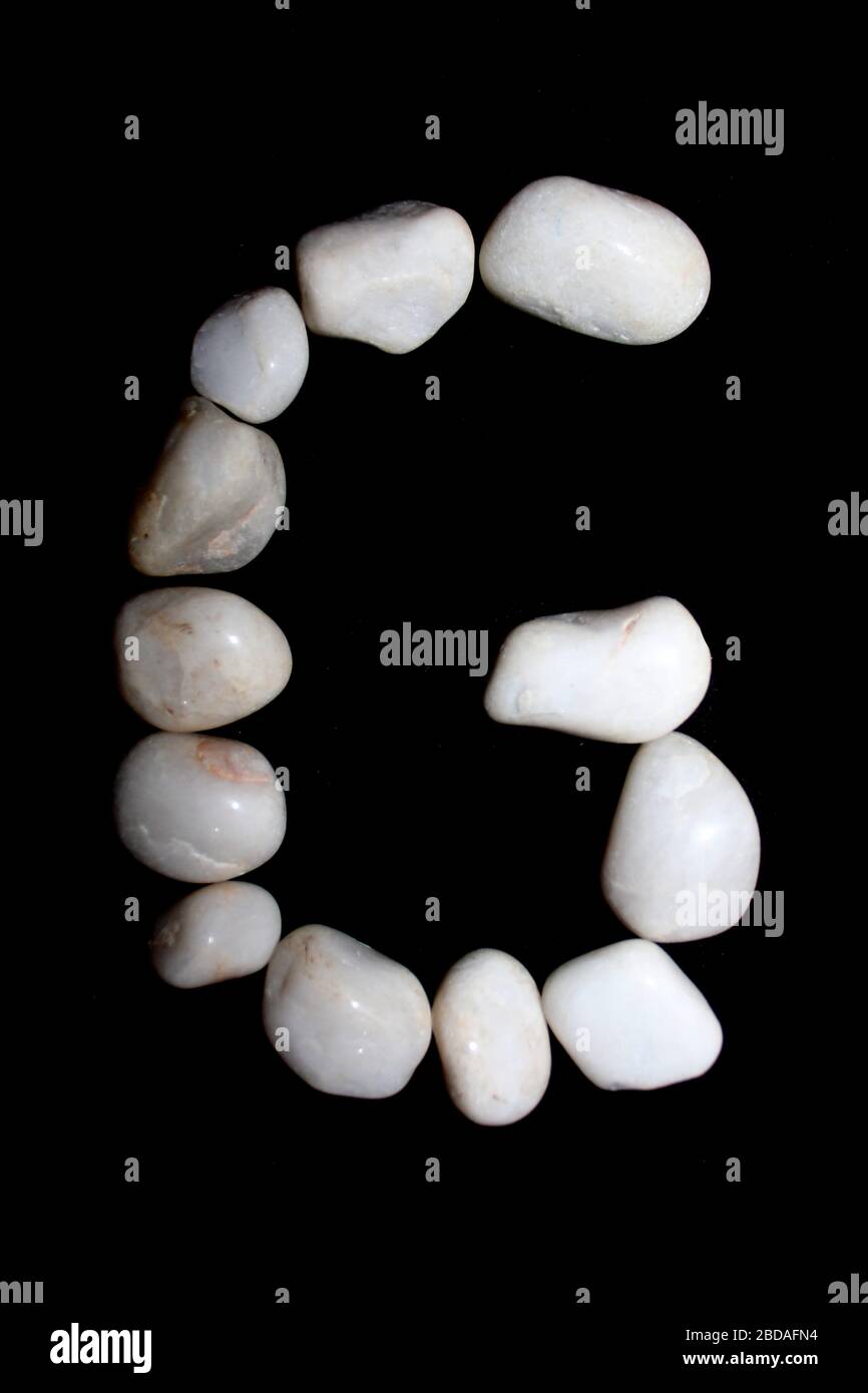 white royal sapphire rock pebbles letter, alphabet photographed against ...