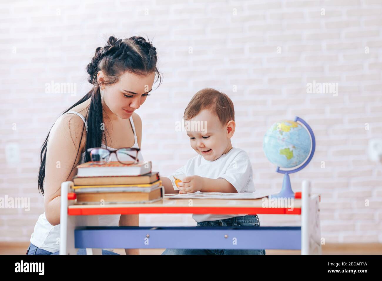 Teaching children with parents Stock Photo - Alamy