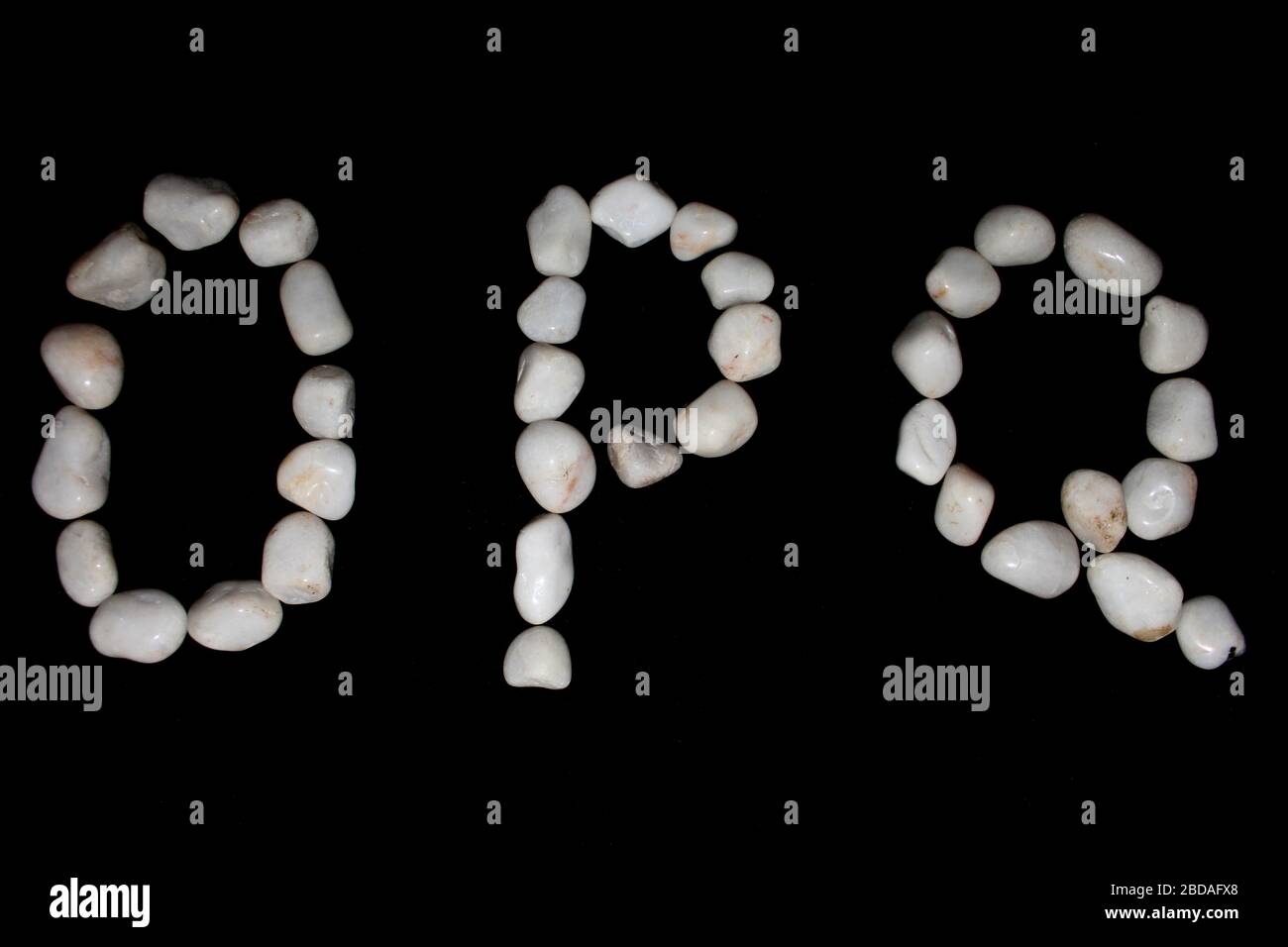 white royal sapphire rock pebbles letter, alphabet photographed against ...
