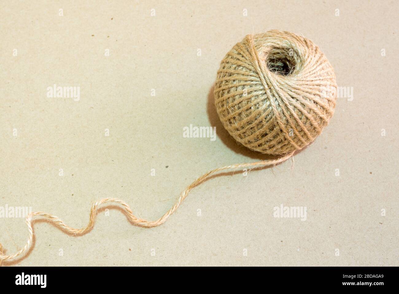 Texture of the brown natural rustic hemp cord in roll on kraft paper ...