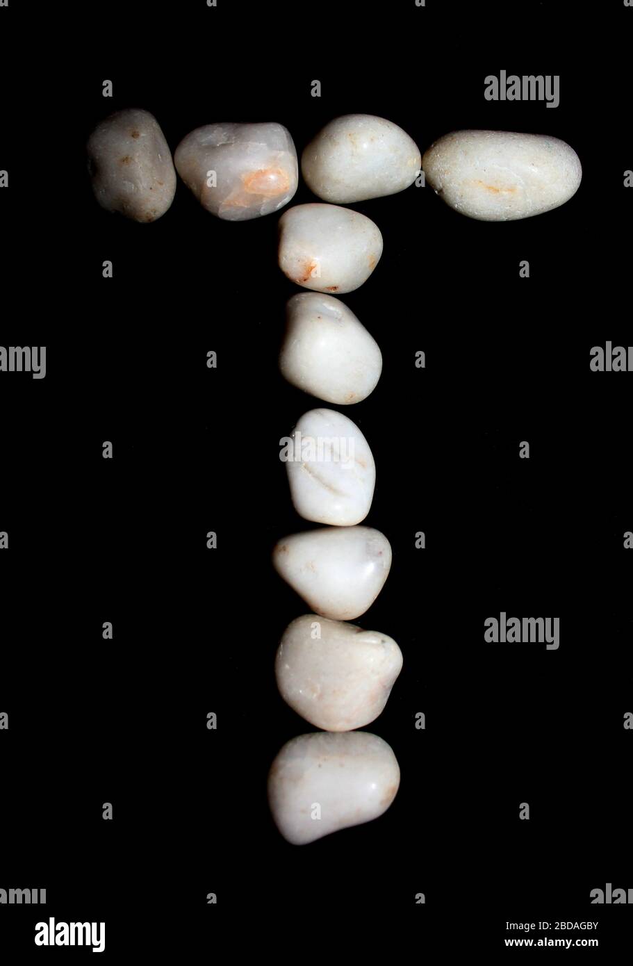 white royal sapphire rock pebbles letter, alphabet photographed against ...