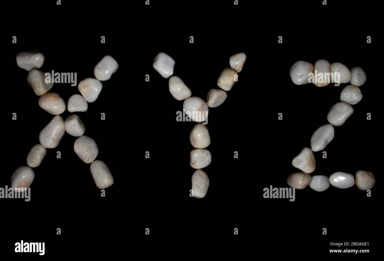white royal sapphire rock pebbles letter, alphabet photographed against ...