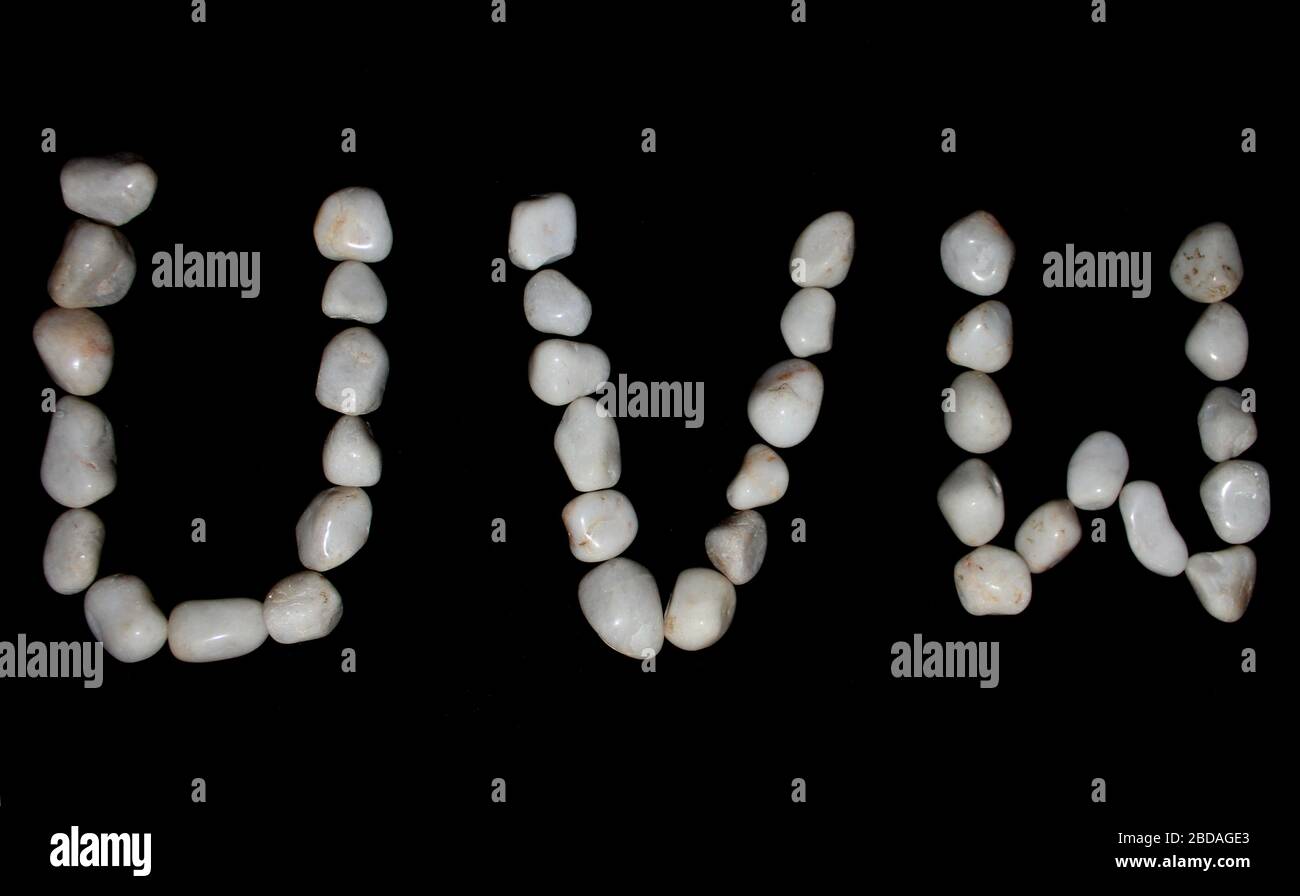 white royal sapphire rock pebbles letter, alphabet photographed against ...
