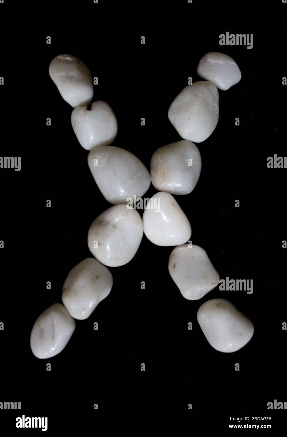 white royal sapphire rock pebbles letter, alphabet photographed against ...