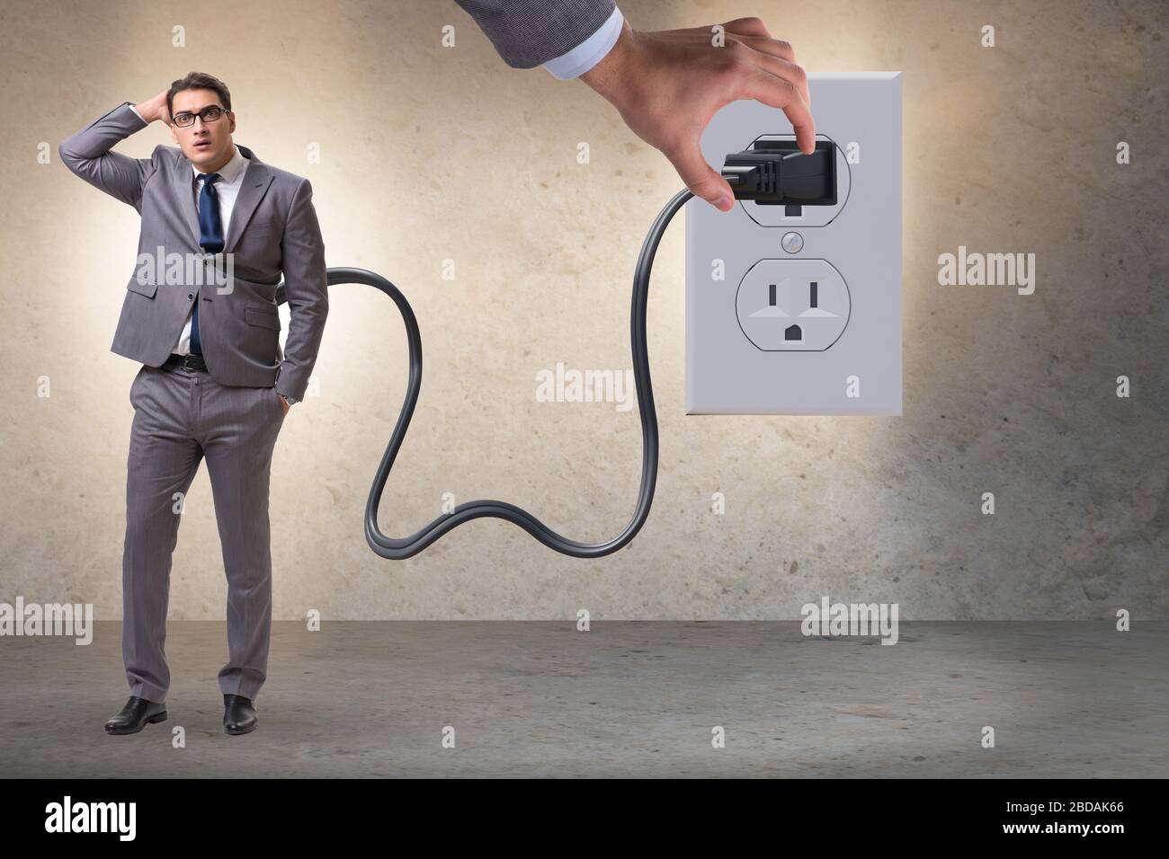 The businessman being powered by electricity and plug Stock Photo - Alamy