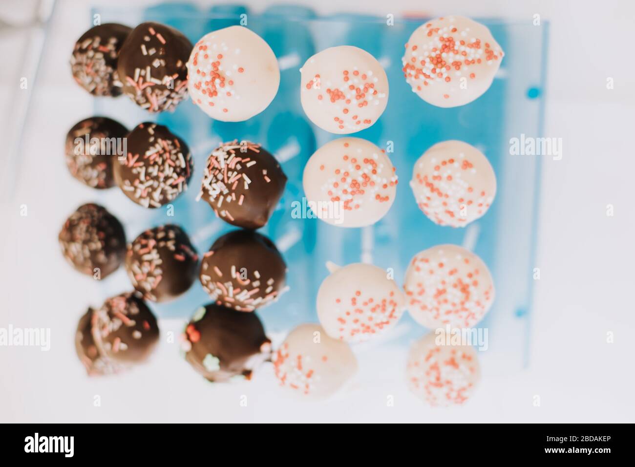 Colorful cake pops with sprinkles over a teal blue background Stock ...