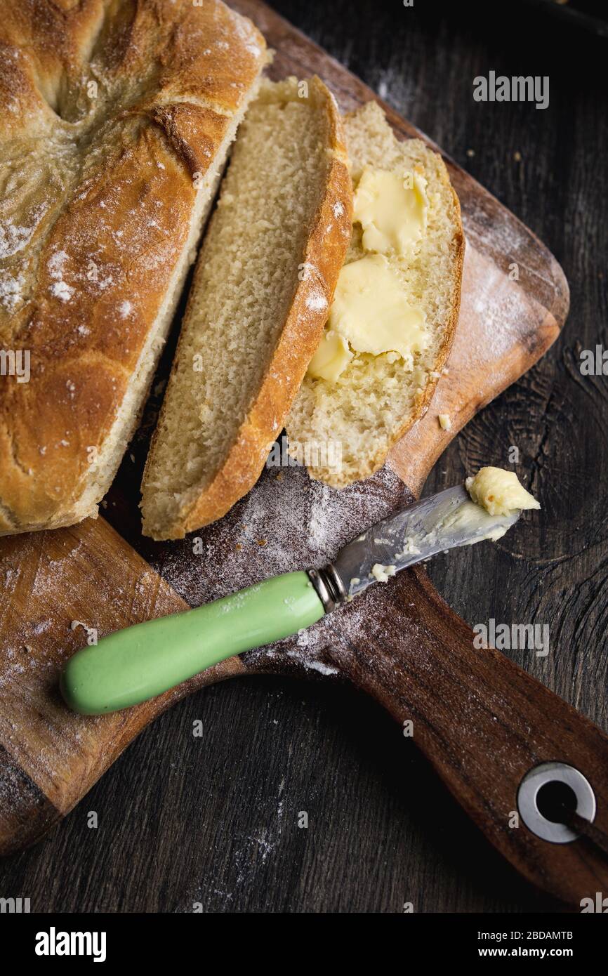 Home made crusty bread on a wooden paddle Stock Photo - Alamy