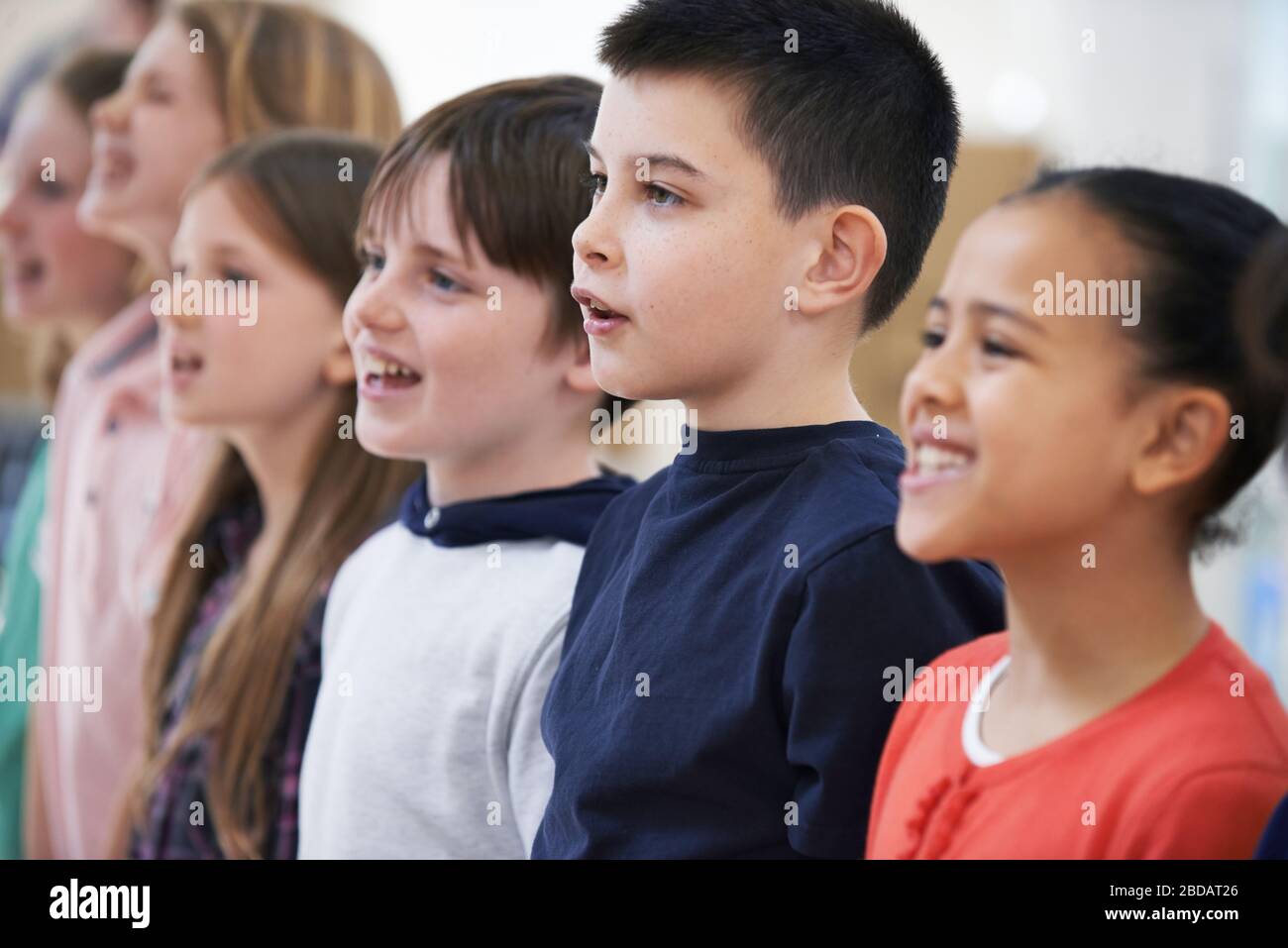 Group Of School Children Singing In Choir At Stage School Together ...