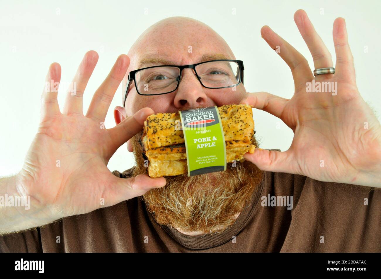 man eating sausage roll Stock Photo - Alamy