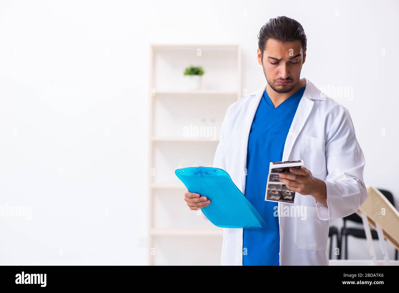 Young doctor working in the clinic Stock Photo - Alamy