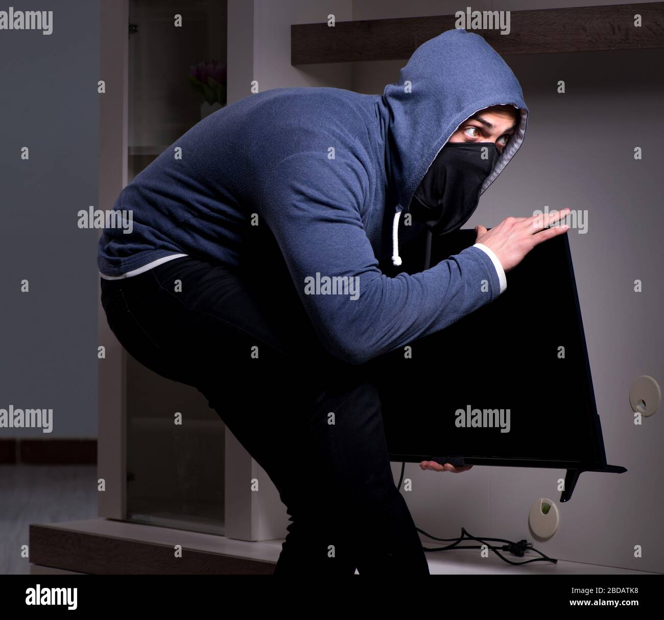The burglar thief stealing tv from apartment house Stock Photo - Alamy