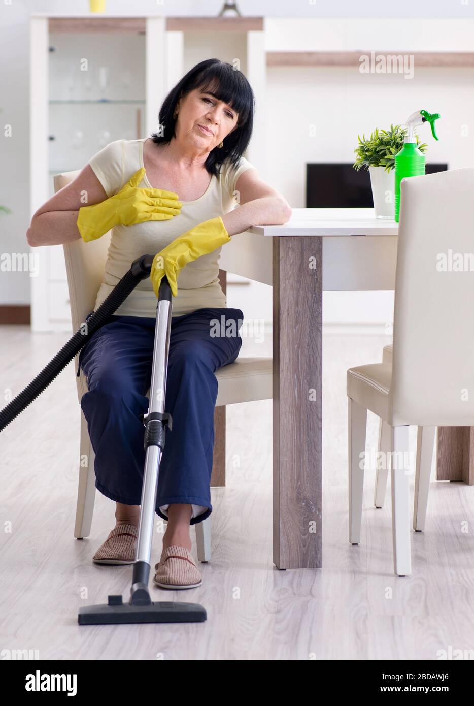 The senior old woman tired after vacuum cleaning house Stock Photo - Alamy