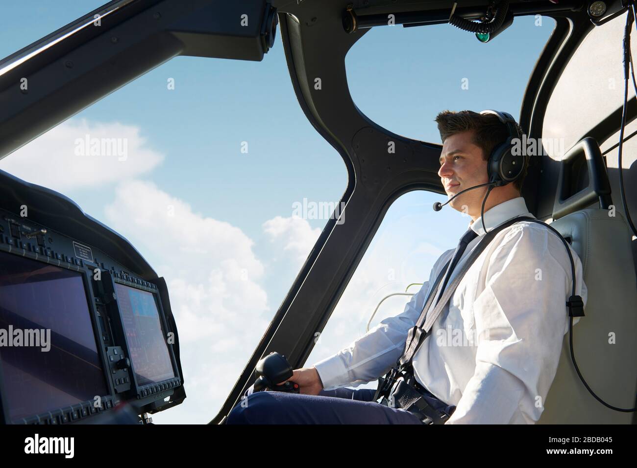 Male Pilot In Cockpit Of Helicopter During Flight Stock Photo - Alamy