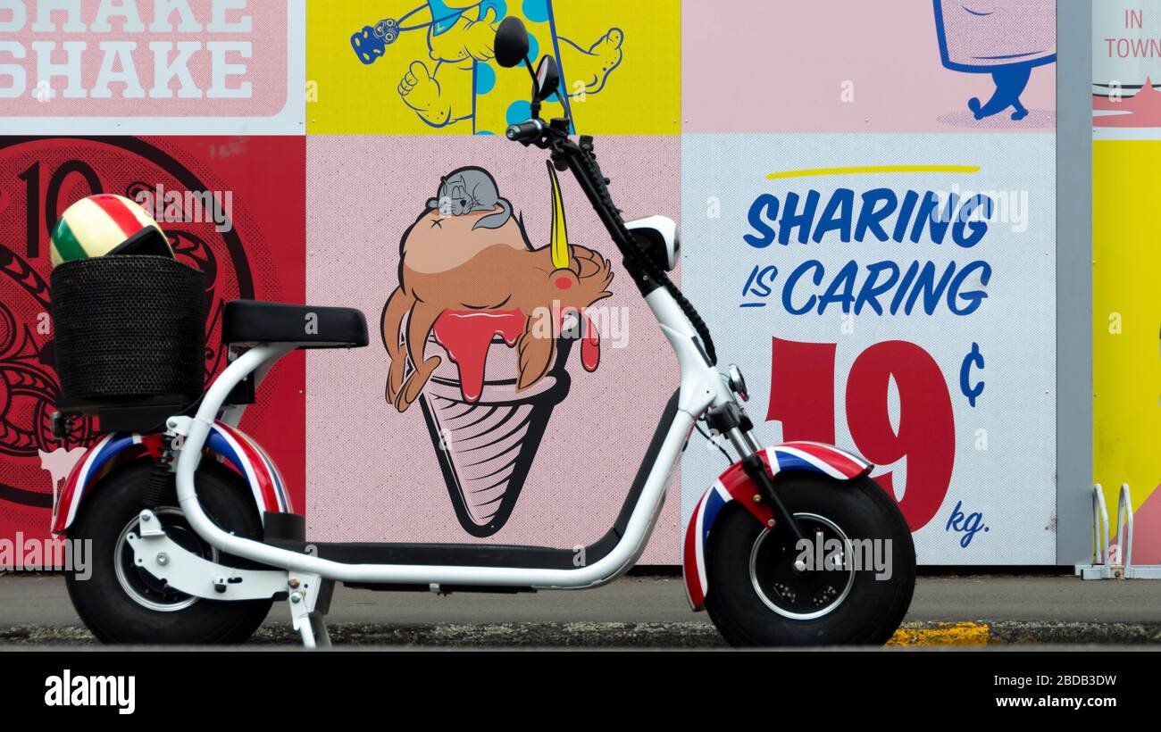 Electric scooter in front of advertising posters on wall, Martinborough ...