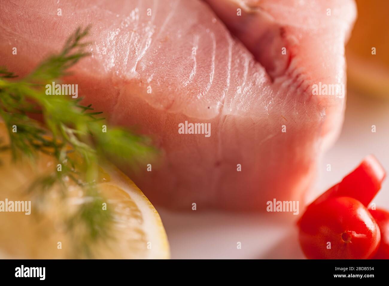 An uncooked slice of fish with red pepper Stock Photo - Alamy