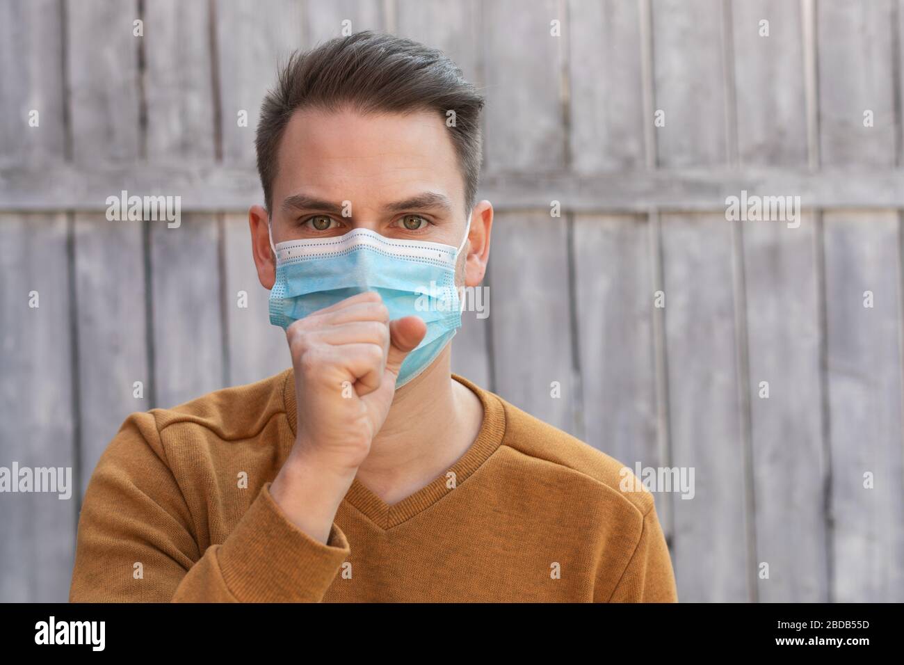 Young handsome man wearing surgical mask because of coronavirus ...